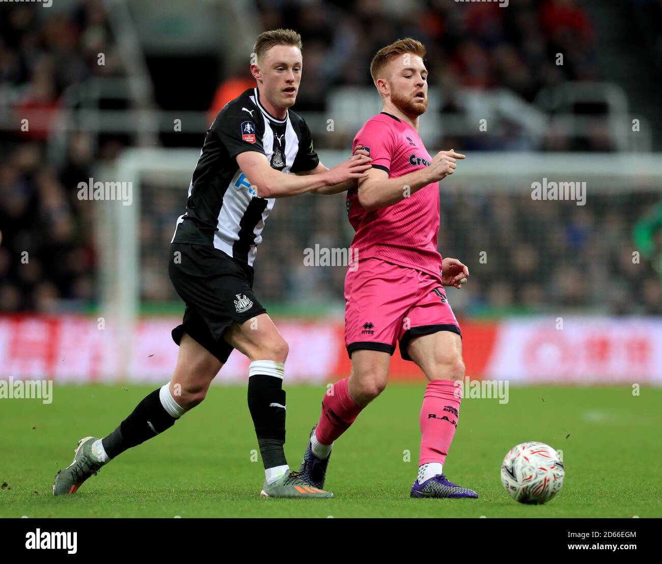 Newcastle United's Sean Longstaff (left) and Rochdale's Callum Camps ...