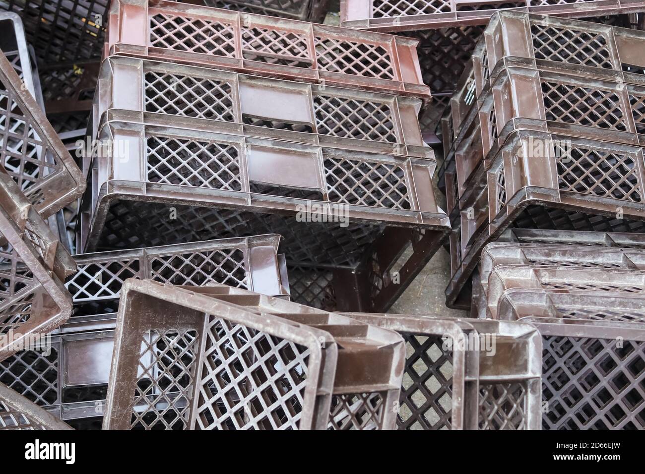 Pile of used grey plastic cargo packaging crates background. Close up ...