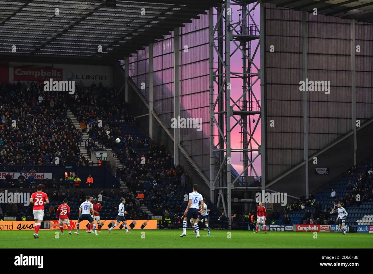 General view of the match action as the sun sets behind Deepdale ...