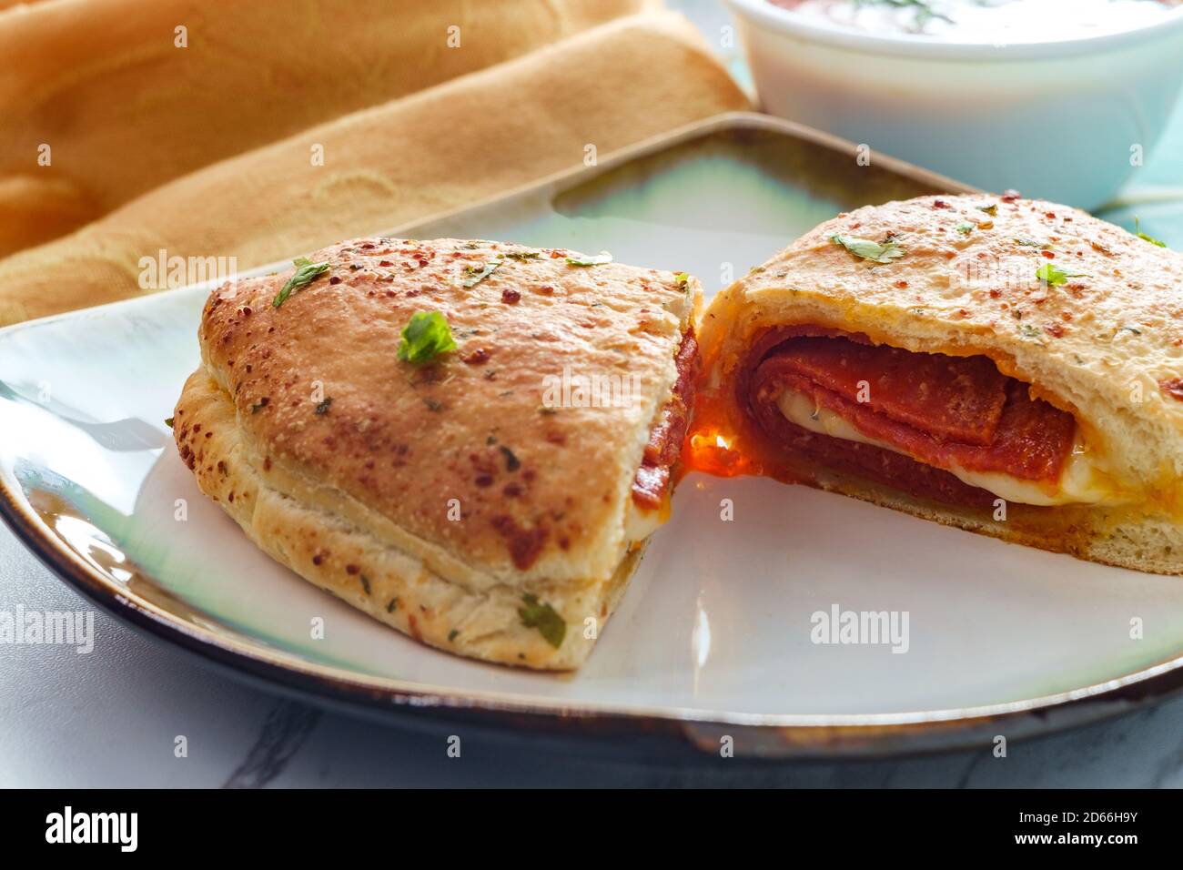 Italian pastry pepperoni and cheese calzone with tomato marinara ...