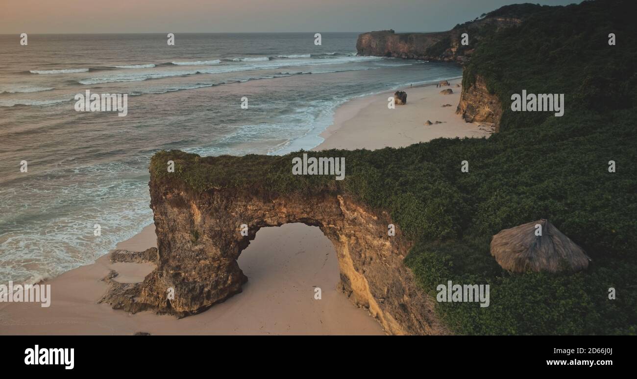 Indonesia landmark closeup aerial: giant hole on cliff wall of Batu ...