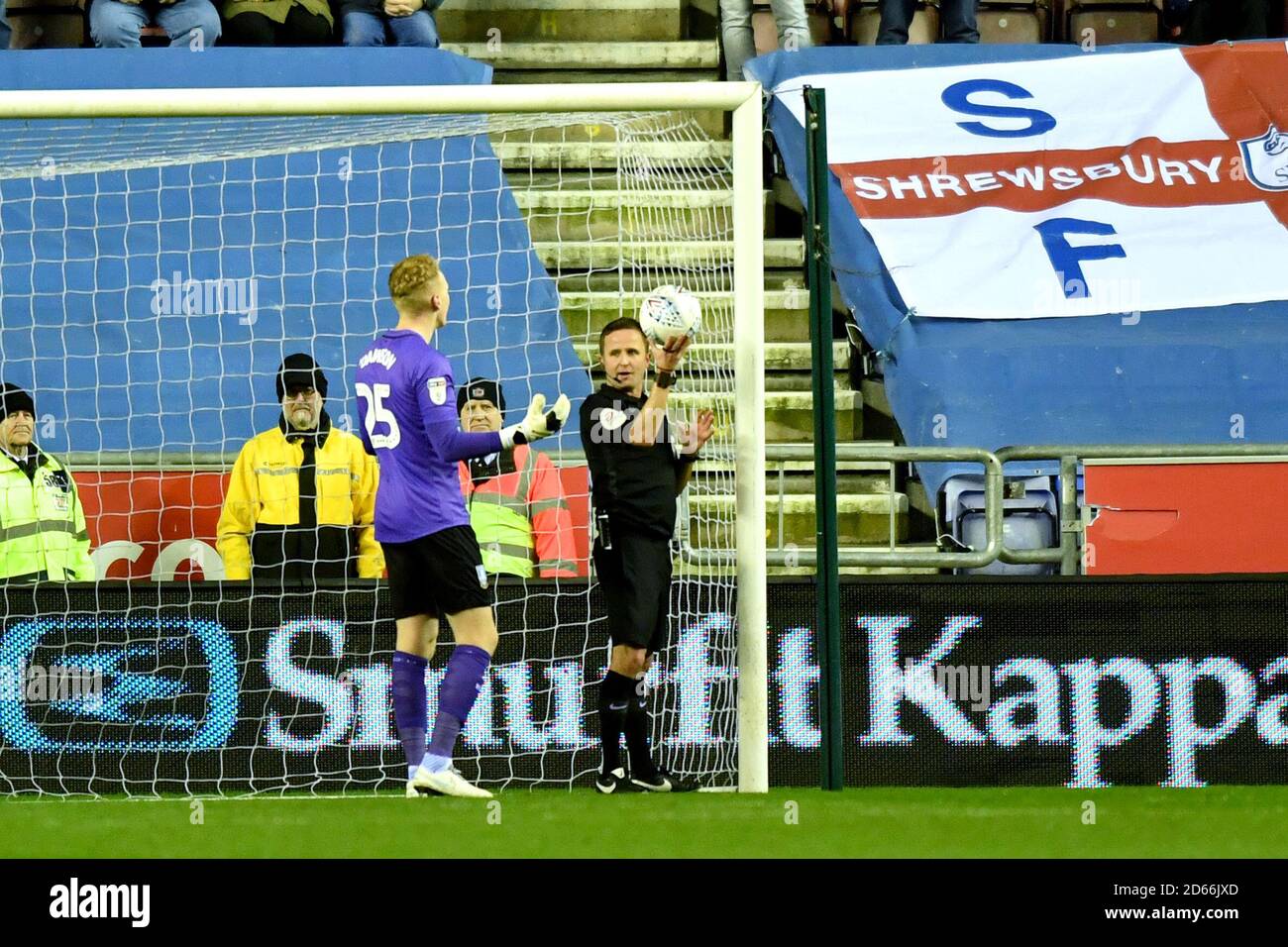 Match referee David Webb stops the game to check the goal line ...