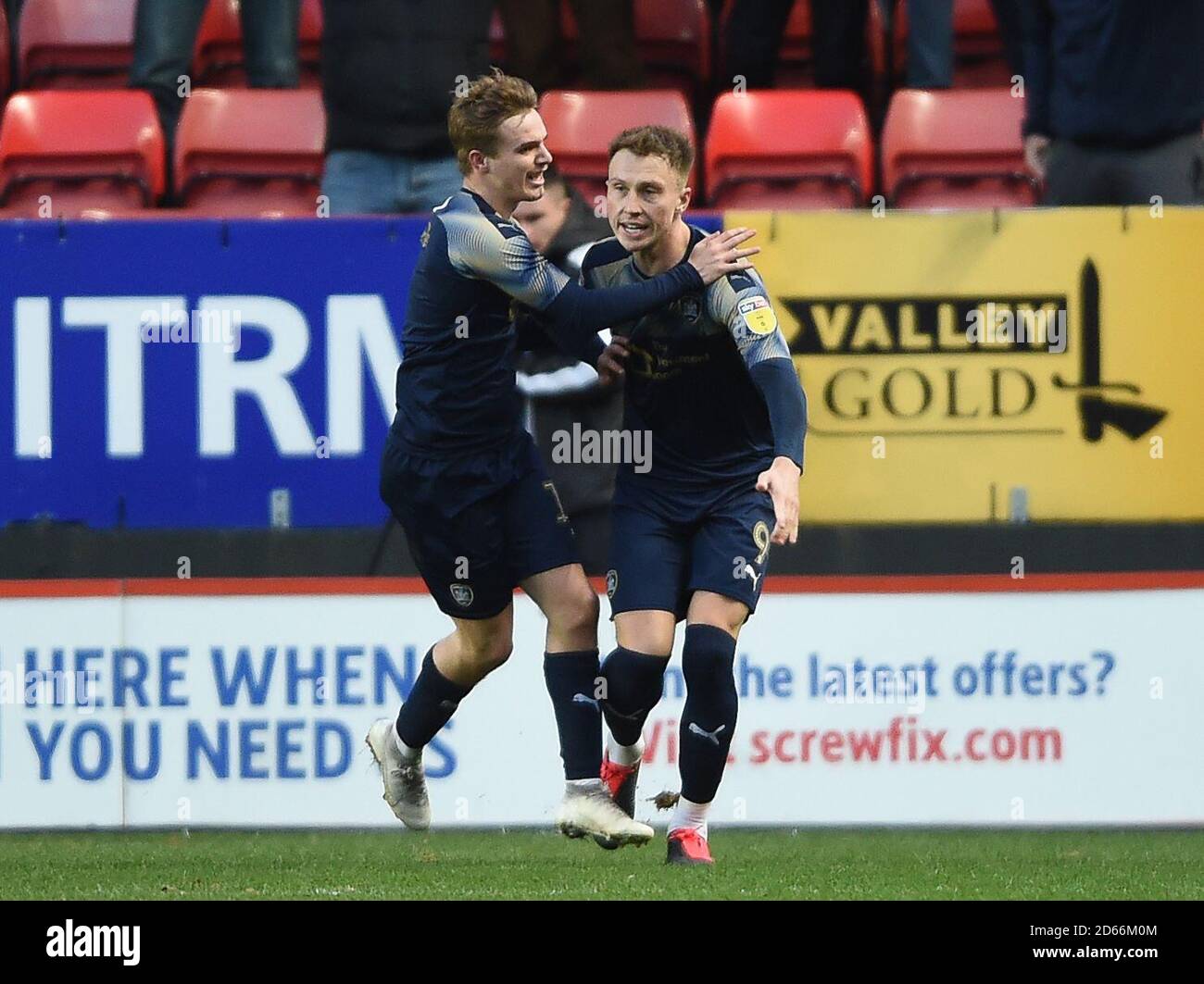 Barnsley's Cauley Woodrow (right) celebrates scoring their first goal ...