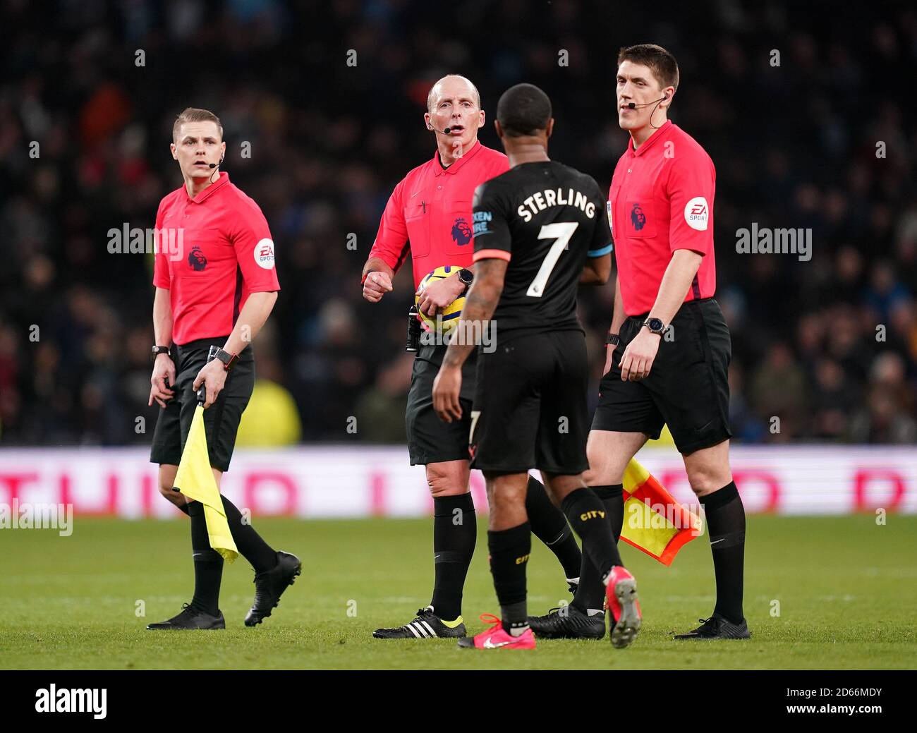 Manchester City's Raheem Sterling speaks with referee Mike Dean at half ...