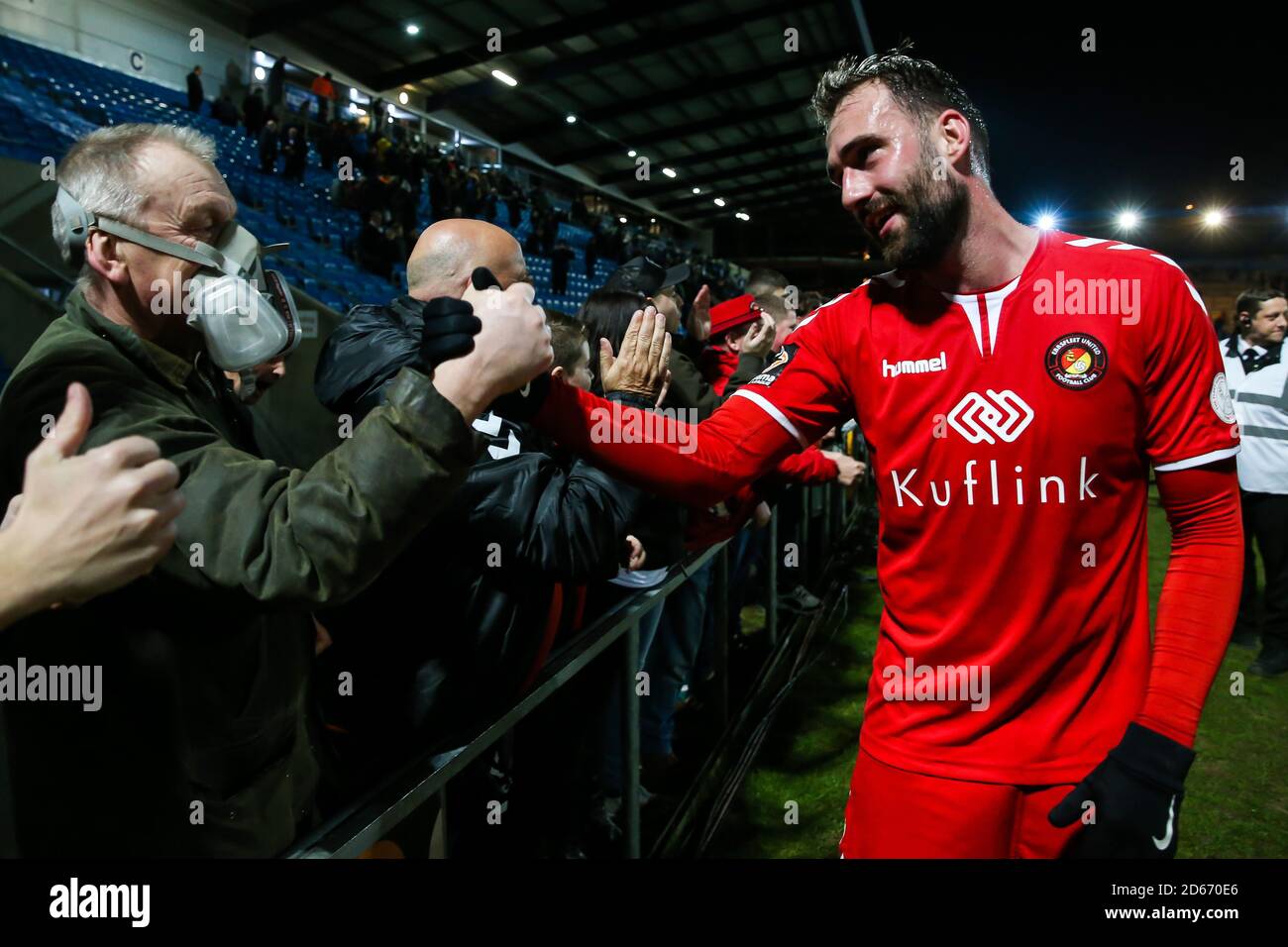 An Ebbsfleet fan wearing a protective mask celebrates the win against ...