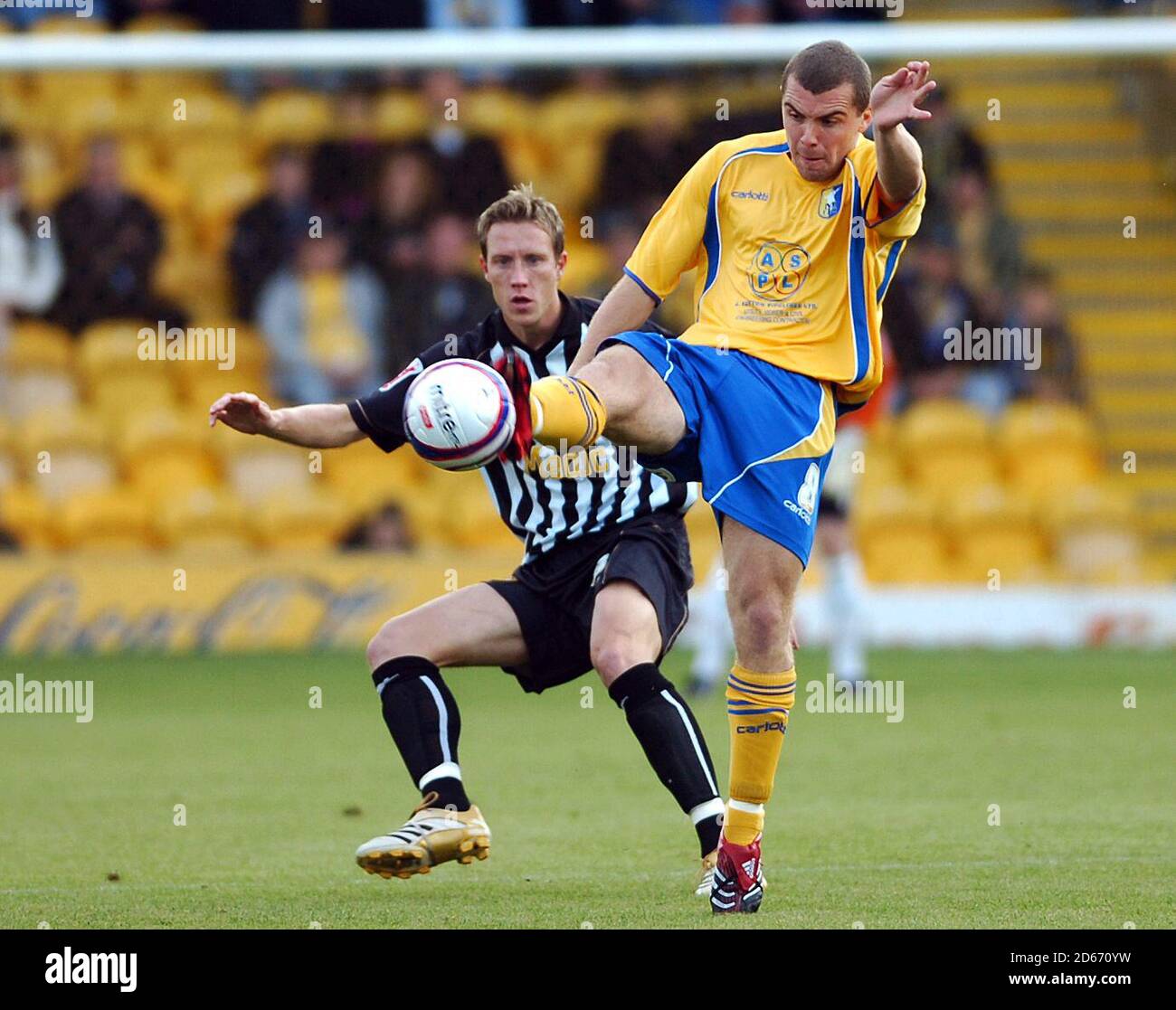 Mansfield Town's Stephen Dawson and Notts County's Neil MacKenzie in ...