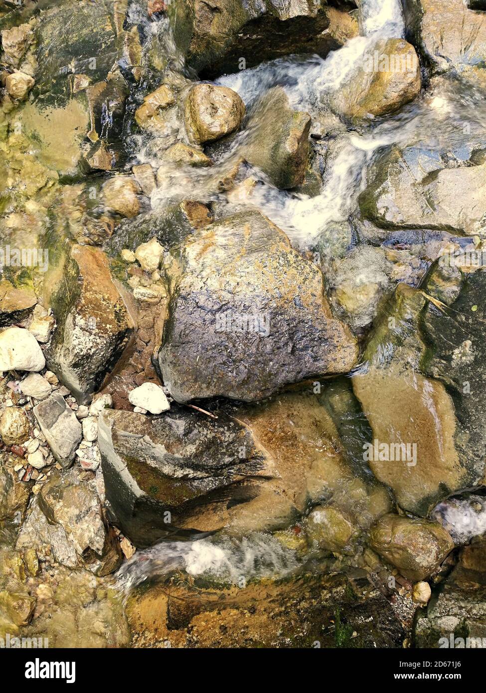 Top view shot of flowing water downstream passing through rocks Stock ...