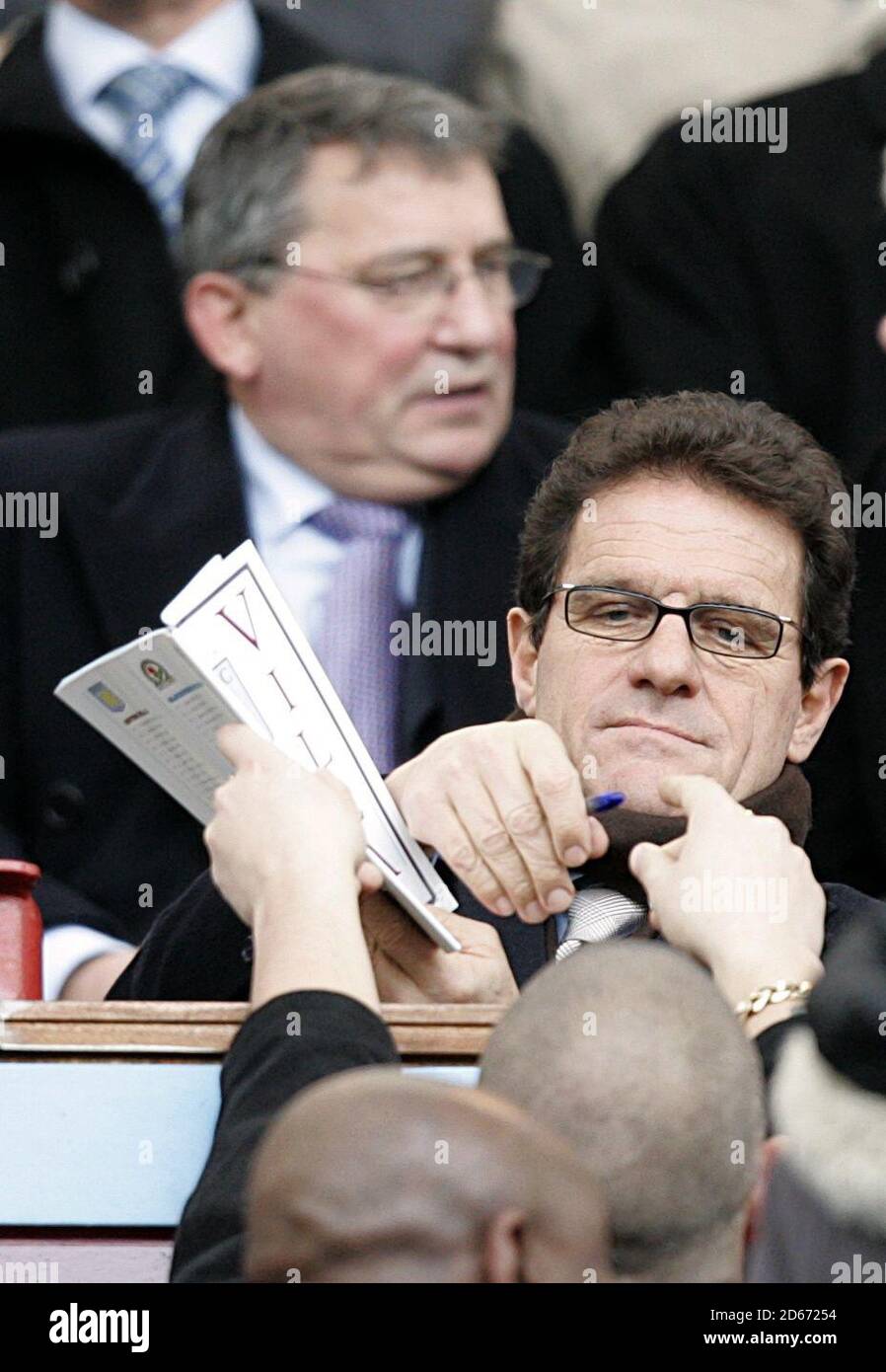 England manager Fabio Capello signs an autograph for a fan in the ...