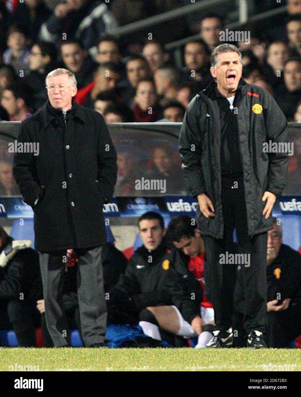 Manchester United manager Sir Alex Ferguson (l) and his assistant ...