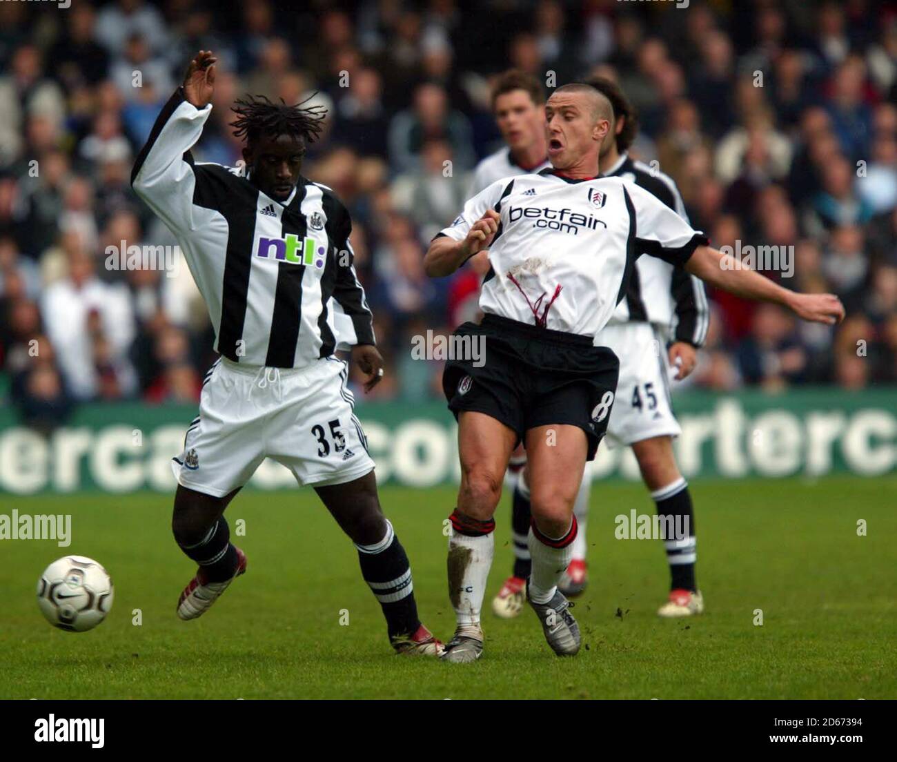 Fulham's Lee Clark and Newcastle United's Olivier Bernard battle for ...