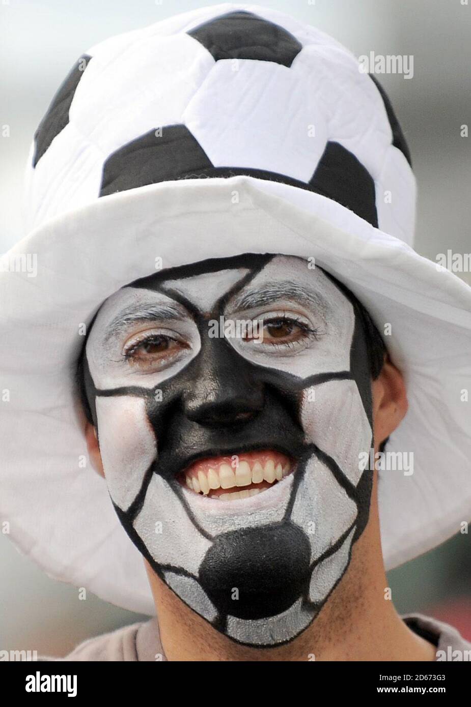 A Football fan with his face painted Stock Photo - Alamy