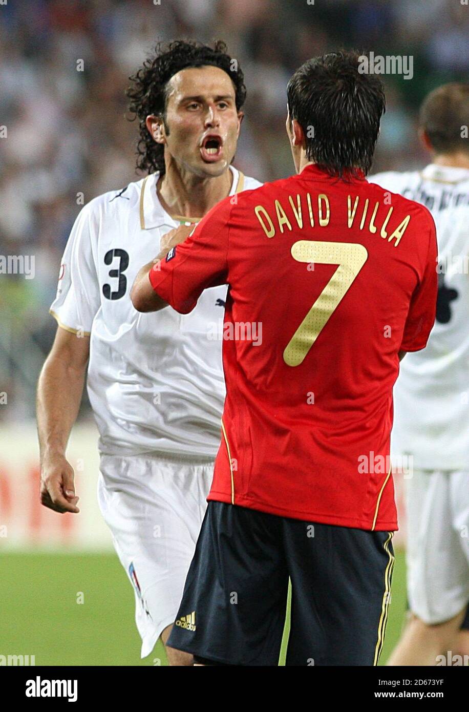 Italy's Fabio Grosso squares up to Spain's David Villa following a ...