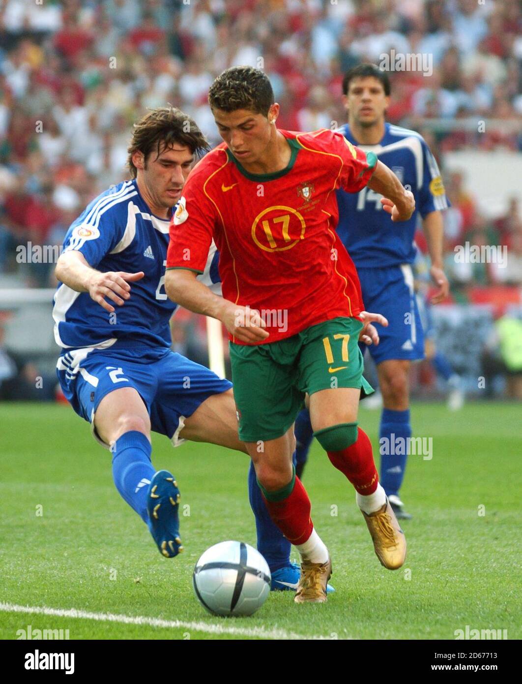 Portugal's Cristiano Ronaldo takes on Greece's Georgios Seitaridis ...