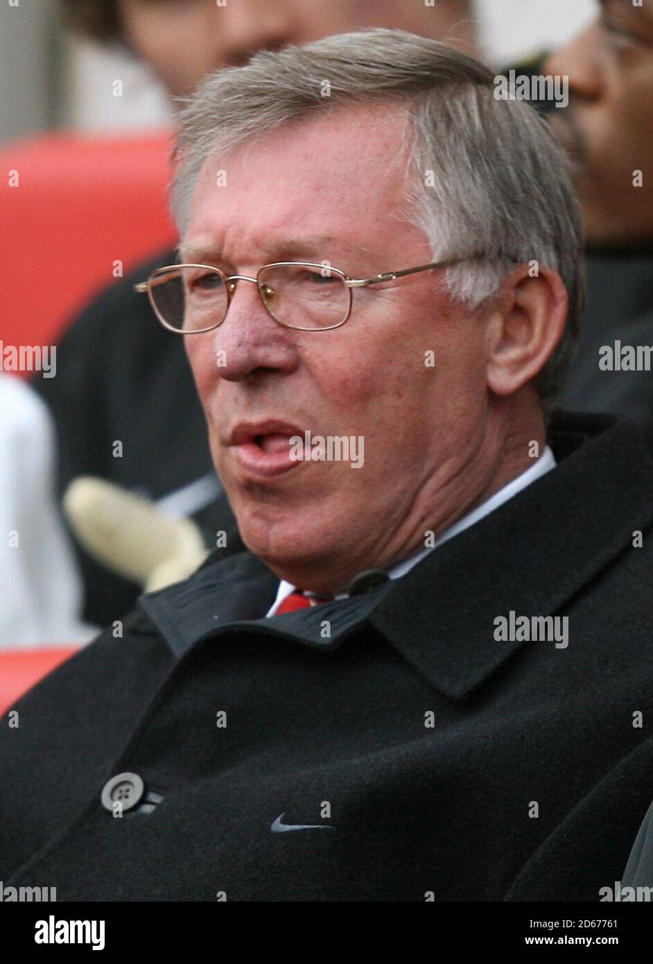 Manchester united manager alex ferguson on the bench hi-res stock ...
