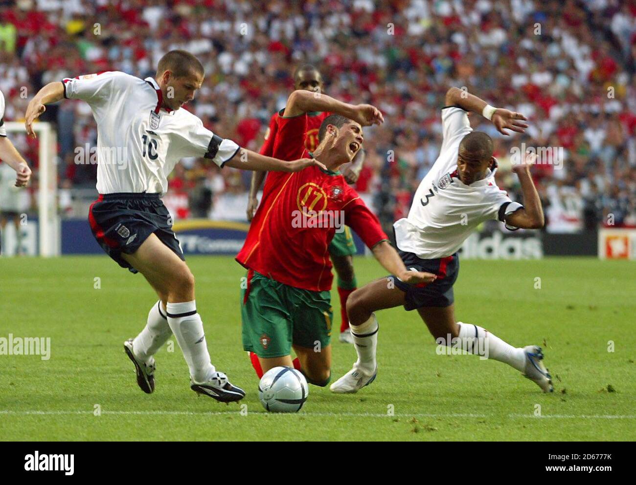 Portugal's Cristiano Ronaldo is tackled by England's Michael Owen and ...