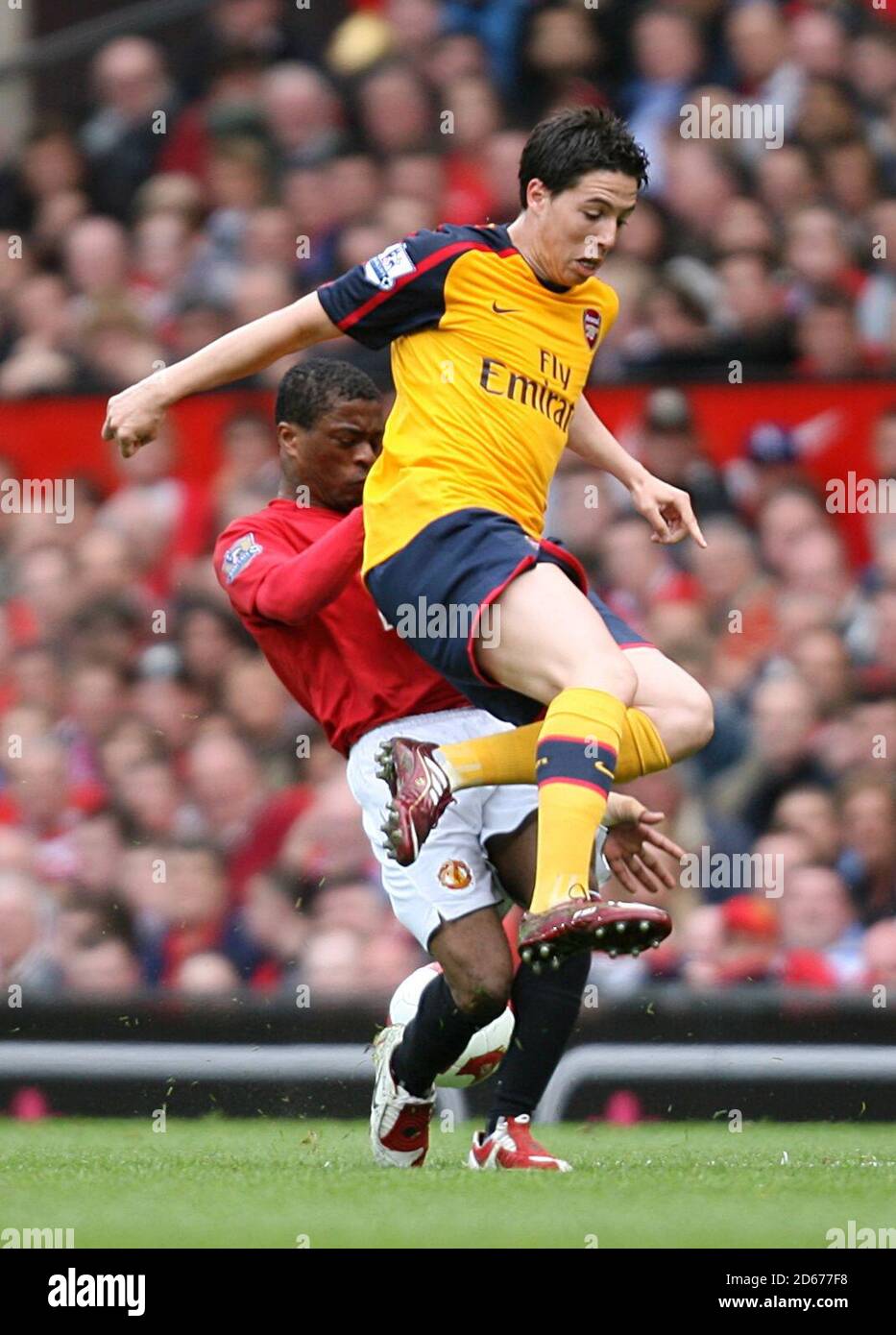 Manchester United's Patrice Evra and Arsenal's Samir Nasri battle for ...