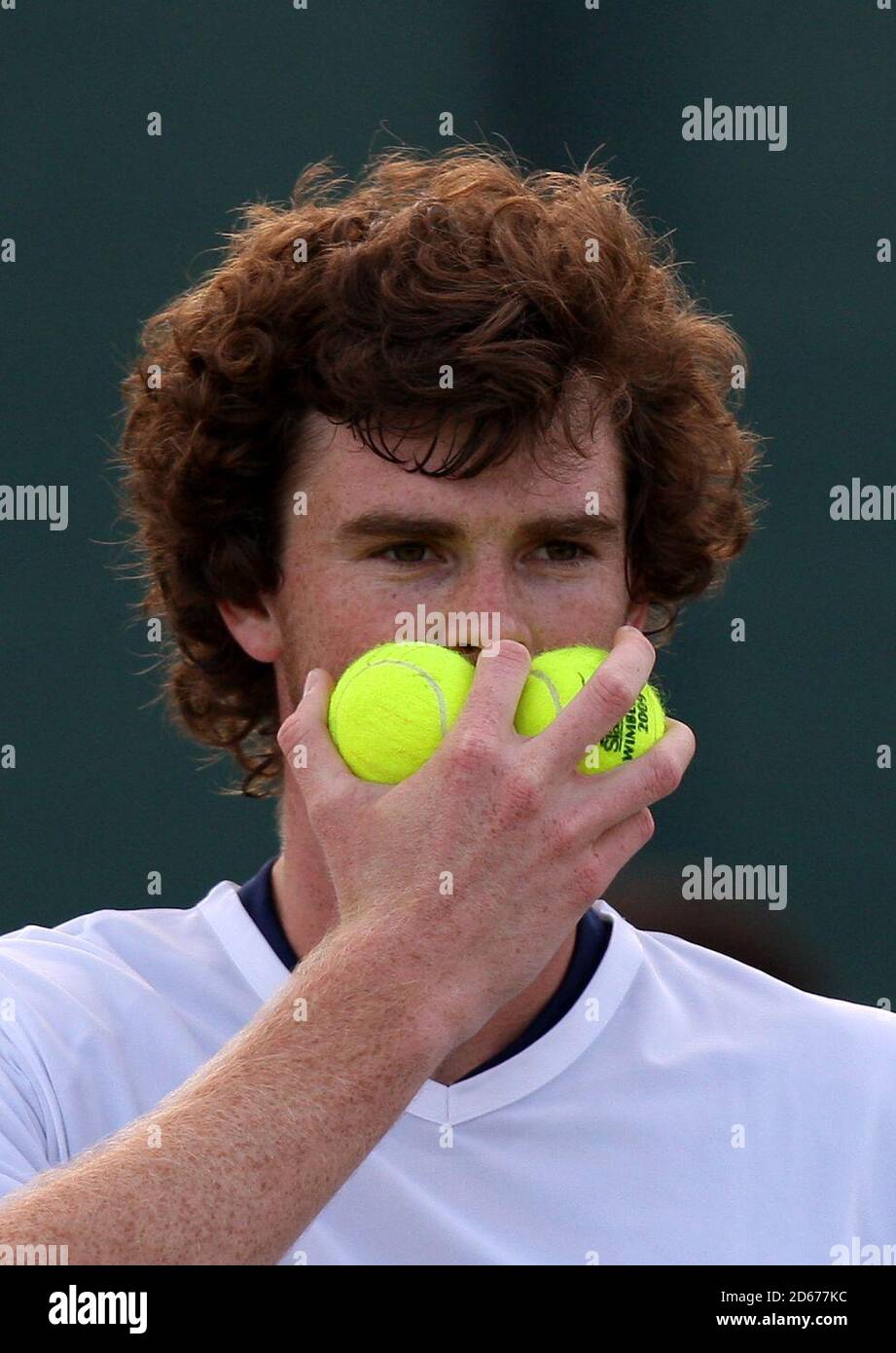 Great Britain's Jamie Murray shields his mouth whilst giving ...
