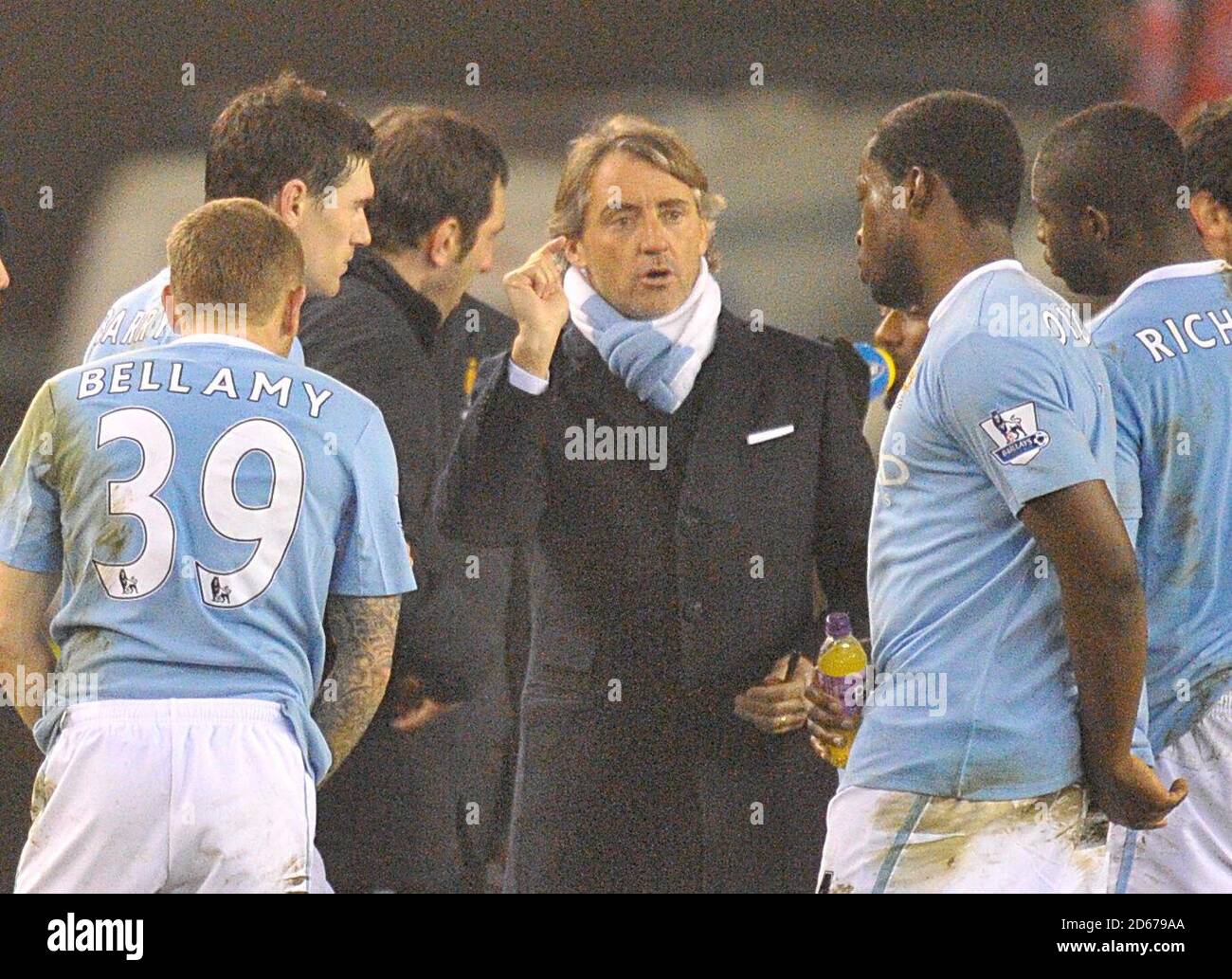 Manchester City manager Roberto Mancini (centre) gives a team talk prior to extra time Stock ...