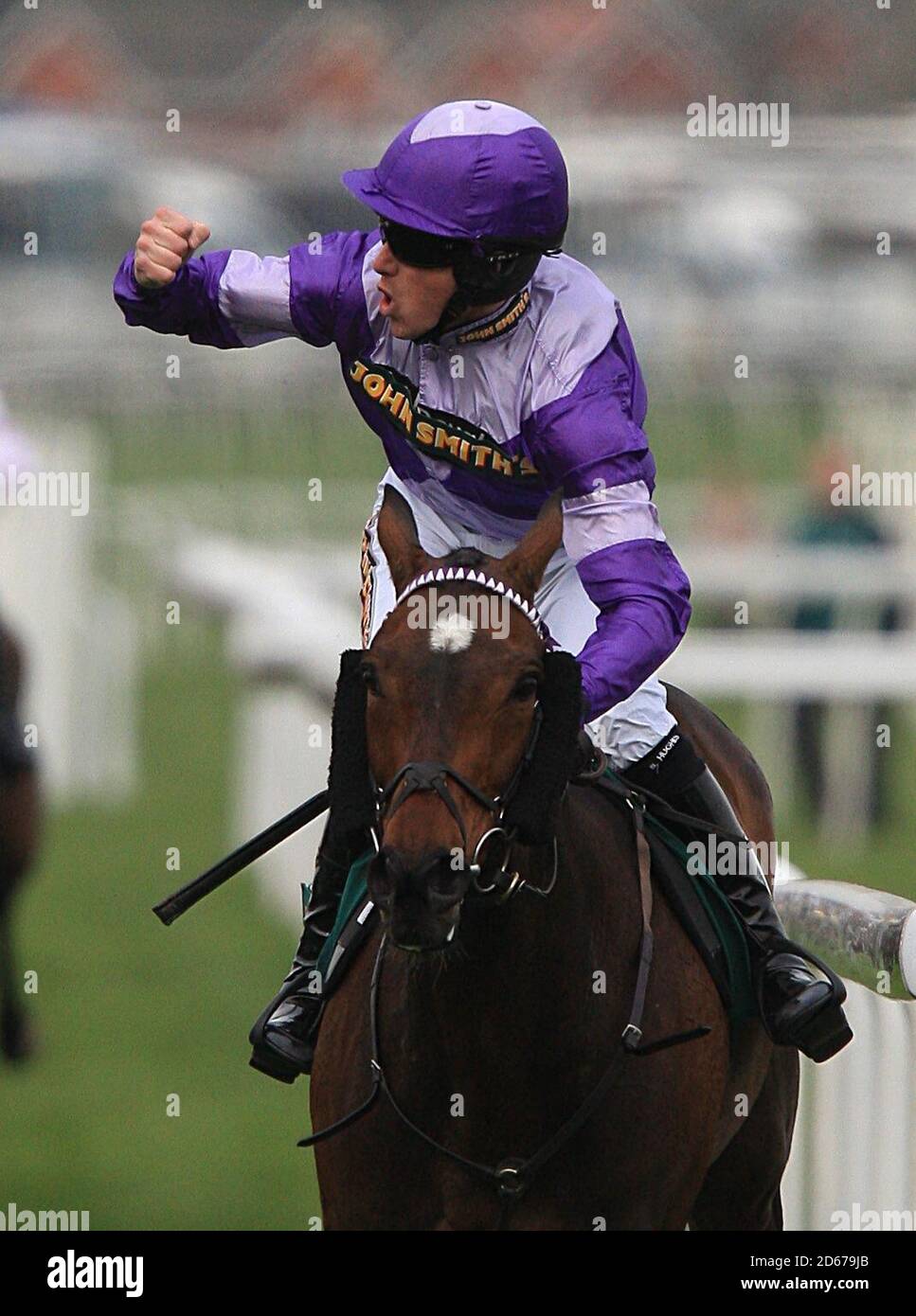 Brian Hughes celebrates winning the John Smith's Topham Chase riding ...