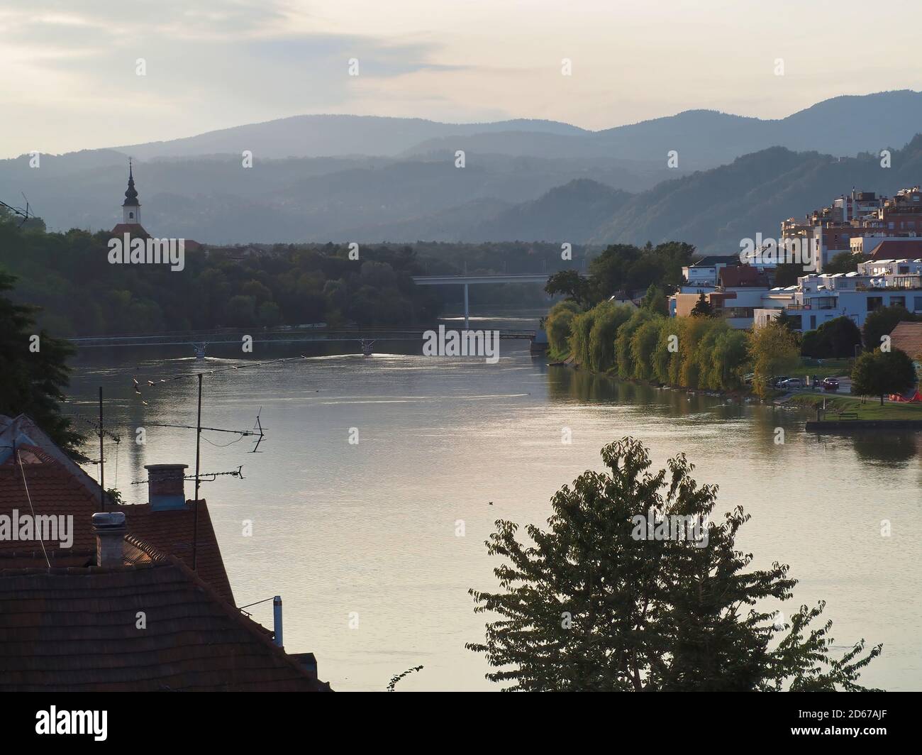 Big river flowing near an old European town Stock Photo - Alamy