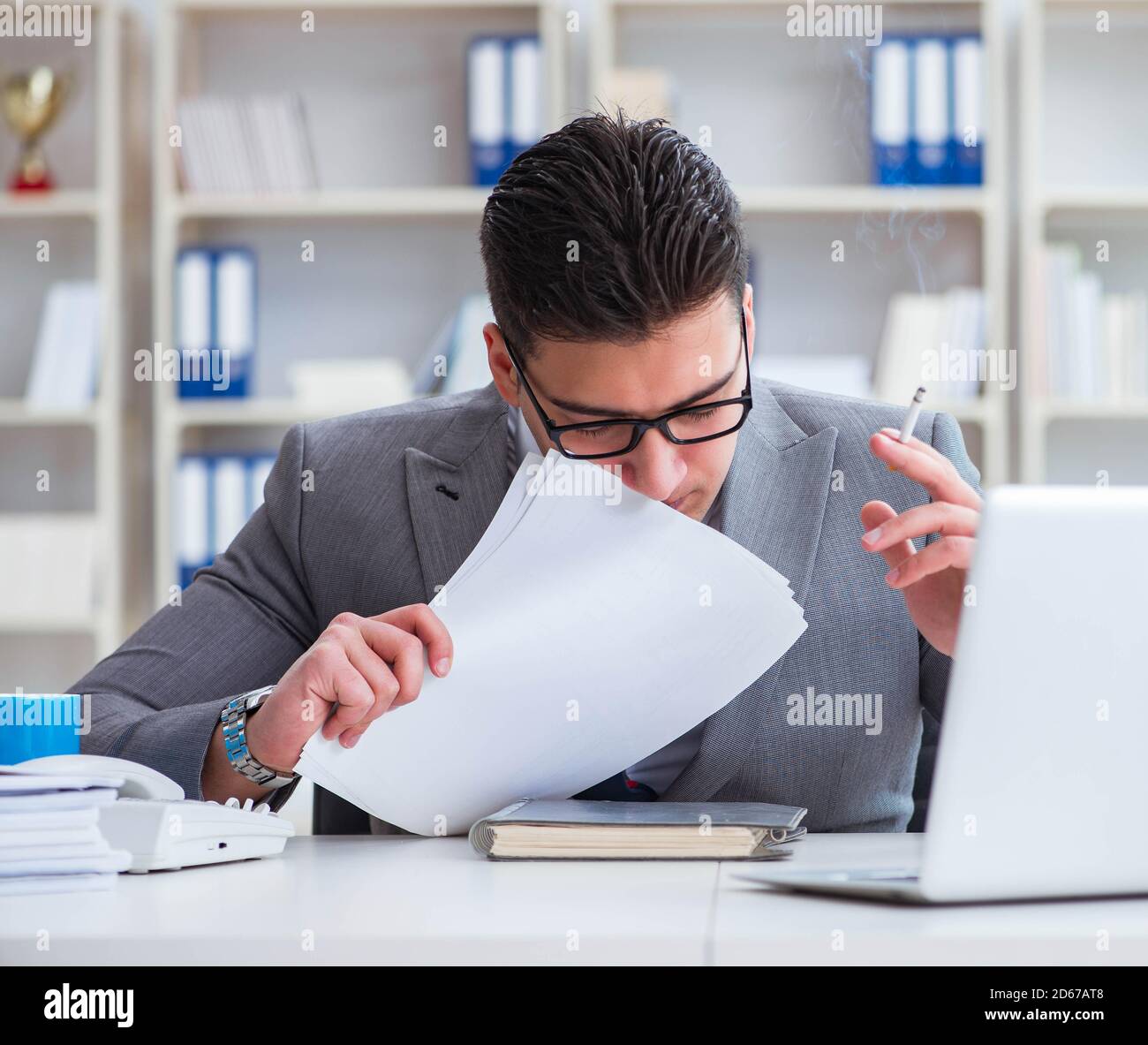 The businessman smoking in office at work Stock Photo - Alamy