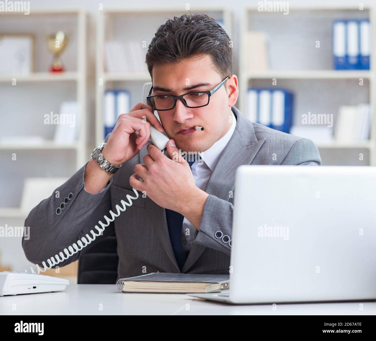 The businessman smoking in office at work Stock Photo - Alamy