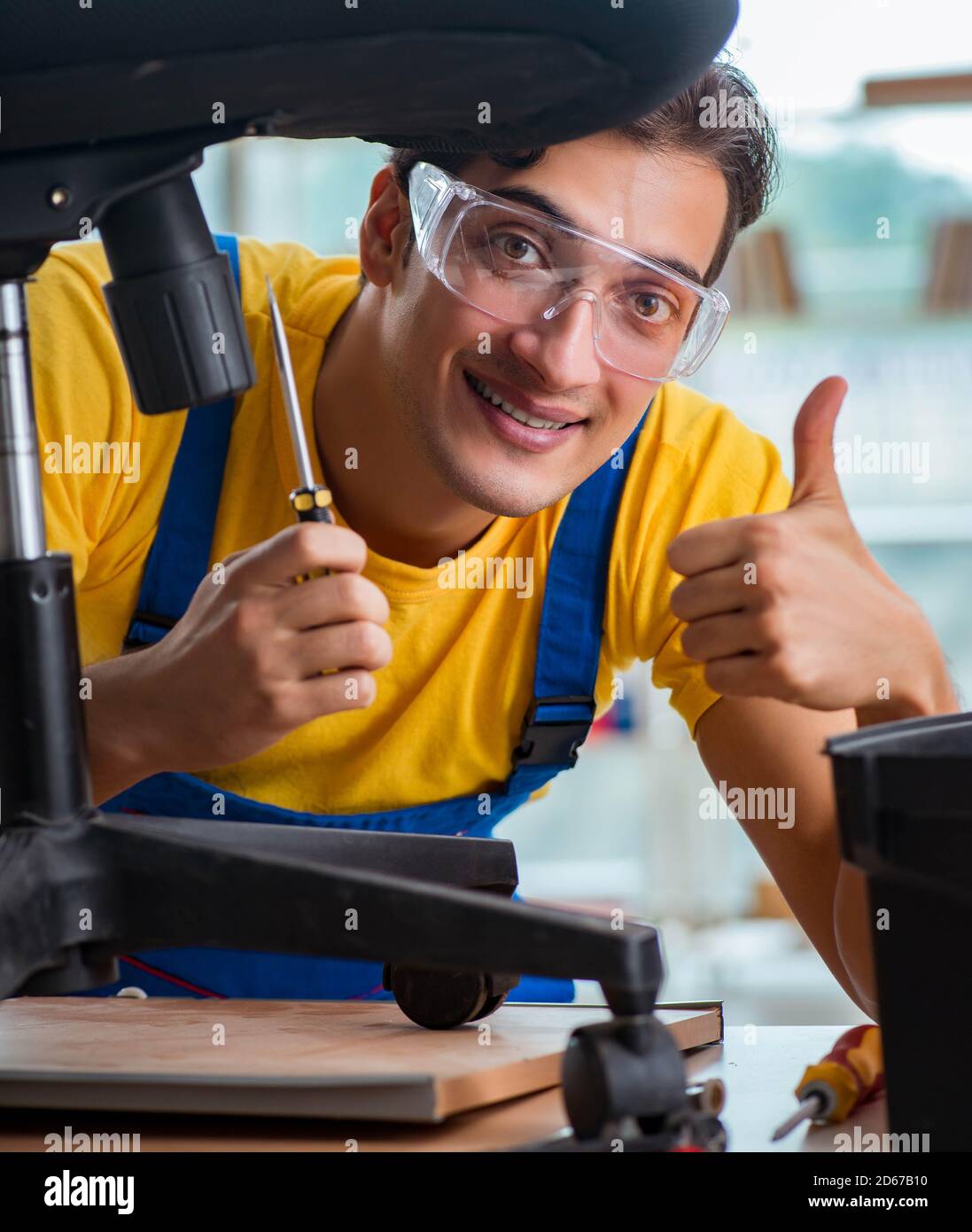 The furniture repairman working on repairing the chair Stock Photo - Alamy