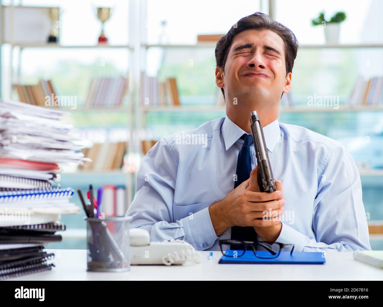 The angry businessman with gun thinking of committing suicide Stock ...