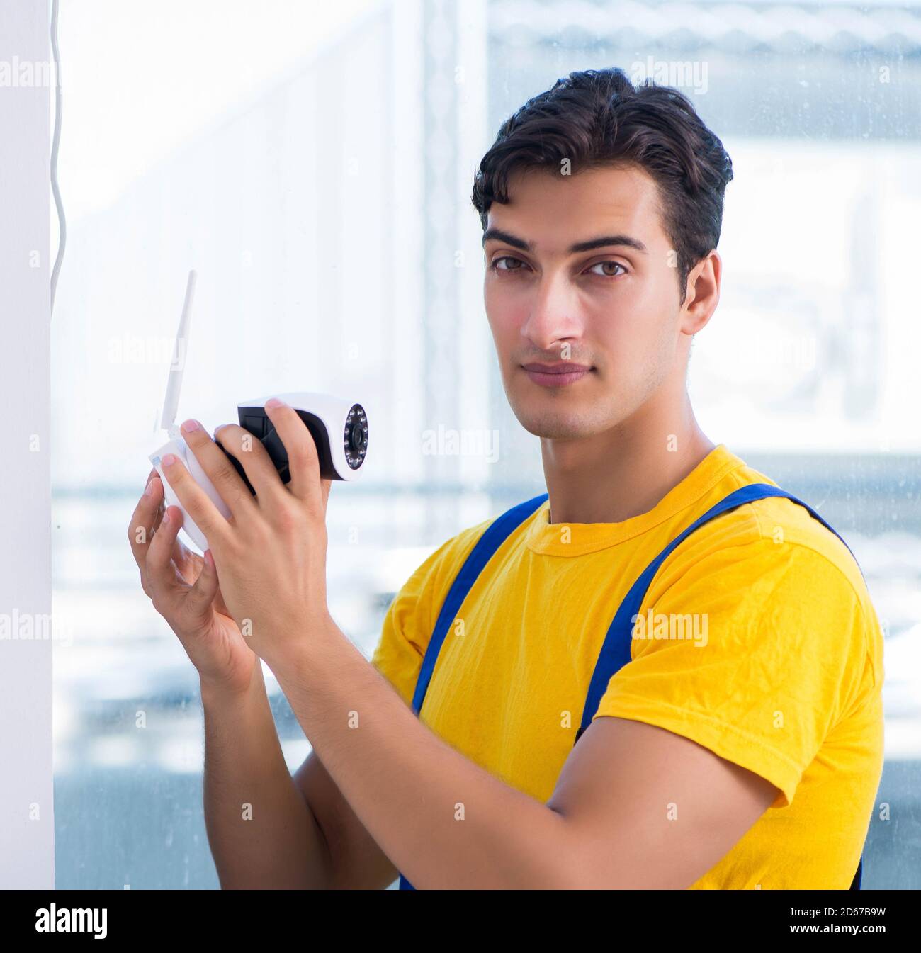 The contractor installing surveillance cctv cameras in office Stock ...