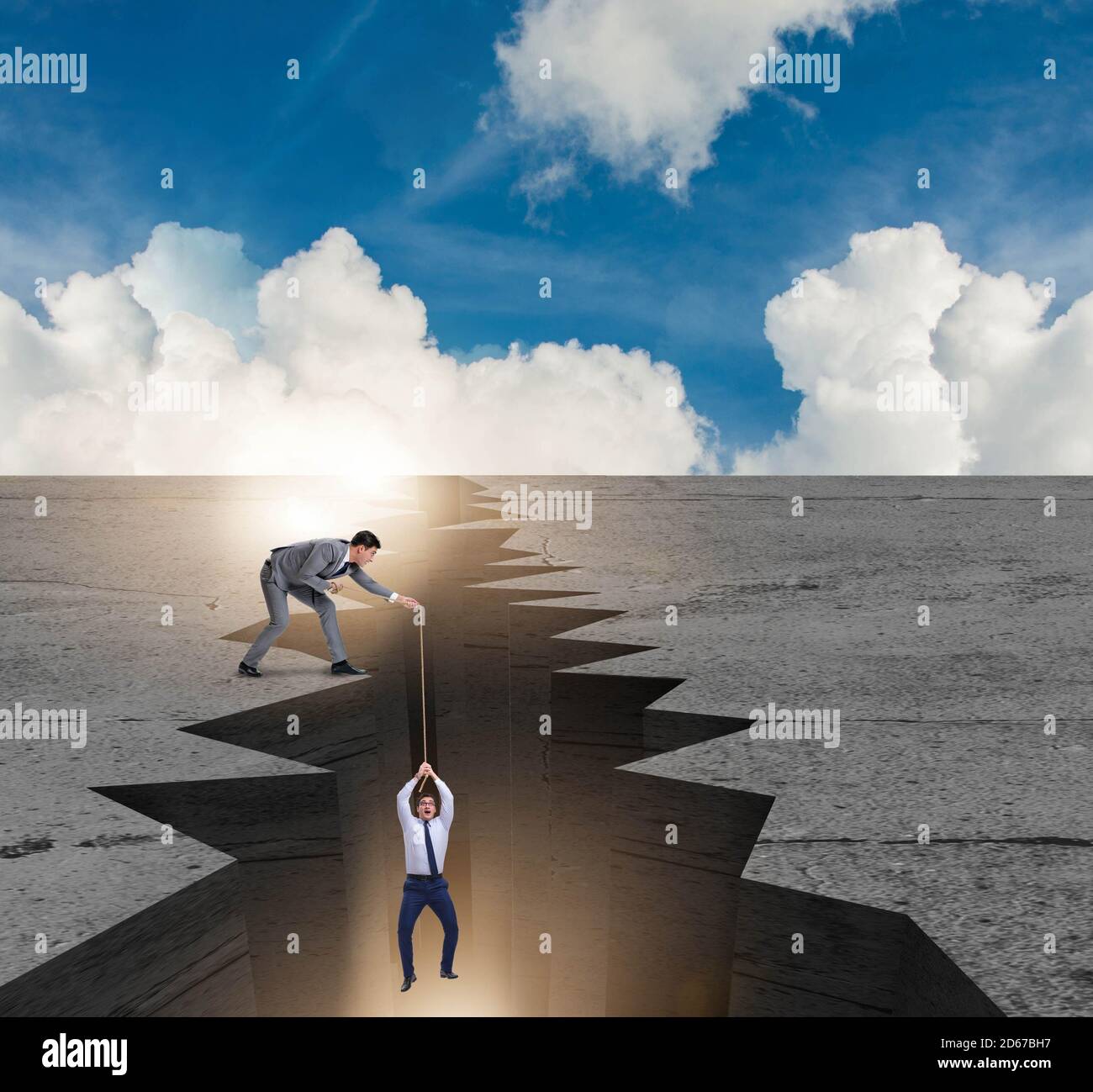 The man saving colleague pulling rope Stock Photo - Alamy