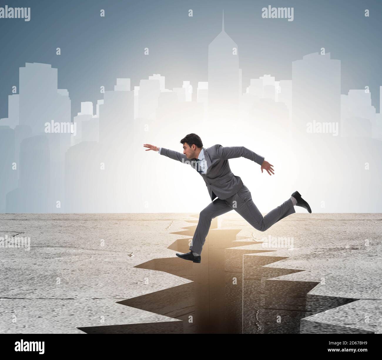 The businessman jumping over the cliff Stock Photo - Alamy