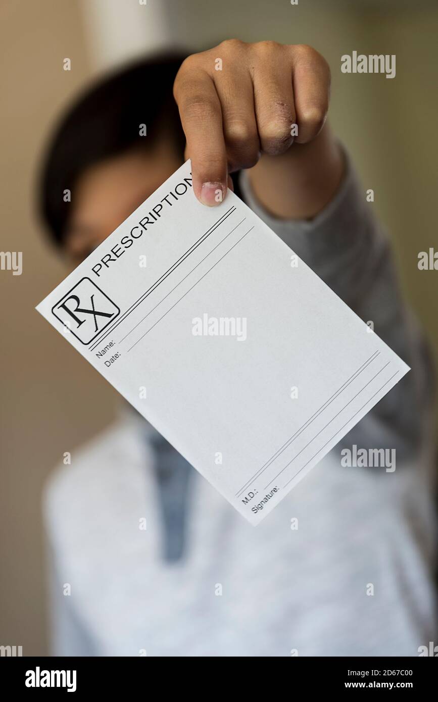 A kid handing over a prescription paper Stock Photo - Alamy