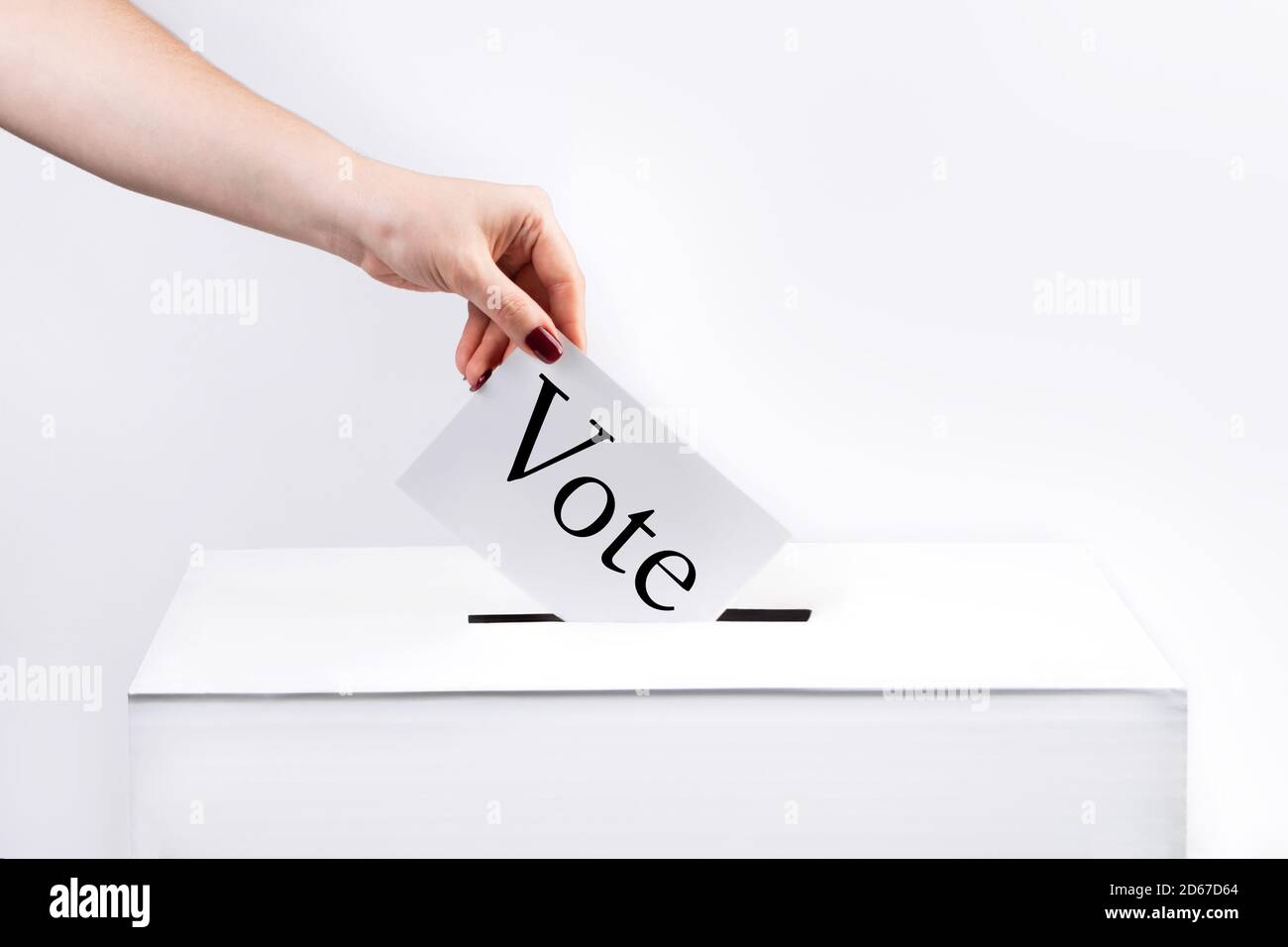 Elections in the United States. Woman puts a ballot in a voting box on ...