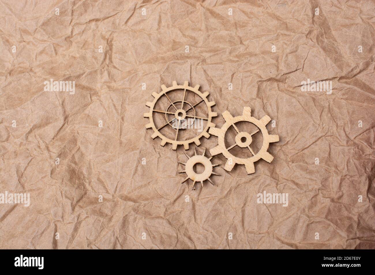Top view of small gear wheel models on a crumbled piece of paper Stock ...