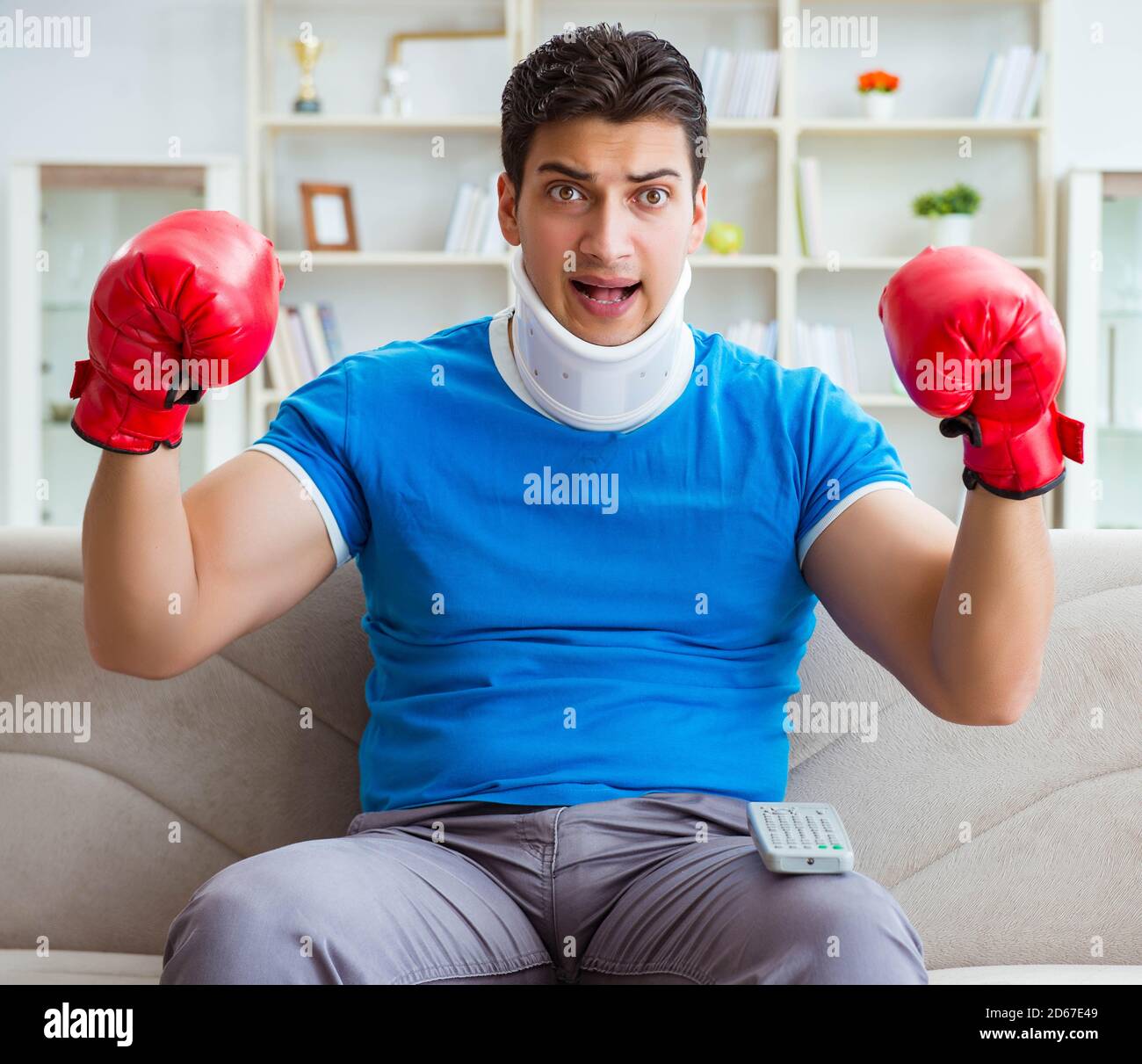The man with neck injury watching boxing at home Stock Photo - Alamy