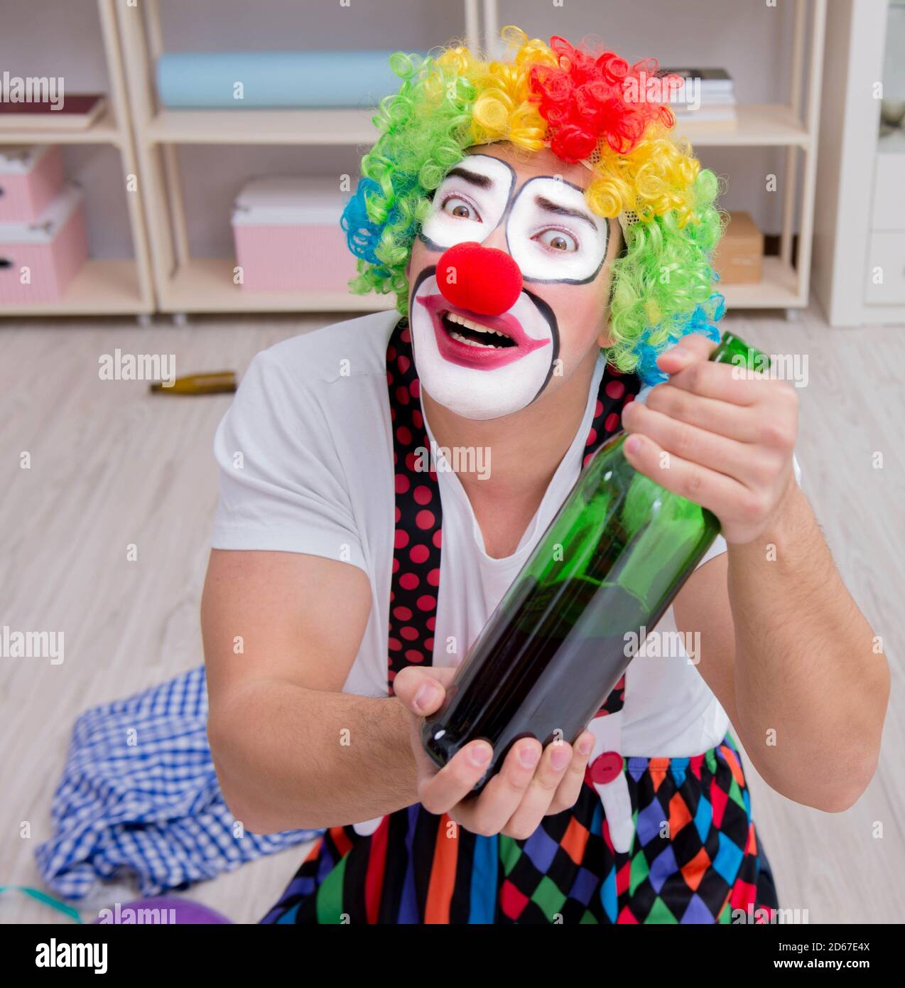 Drunk clown celebrating having a party at home Stock Photo - Alamy