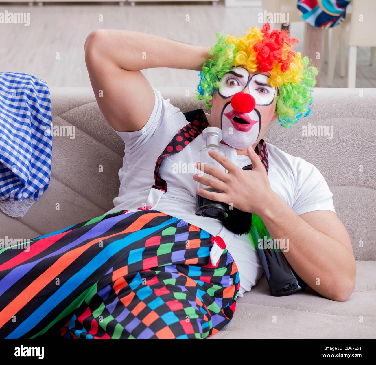 Drunk clown celebrating having a party at home Stock Photo - Alamy