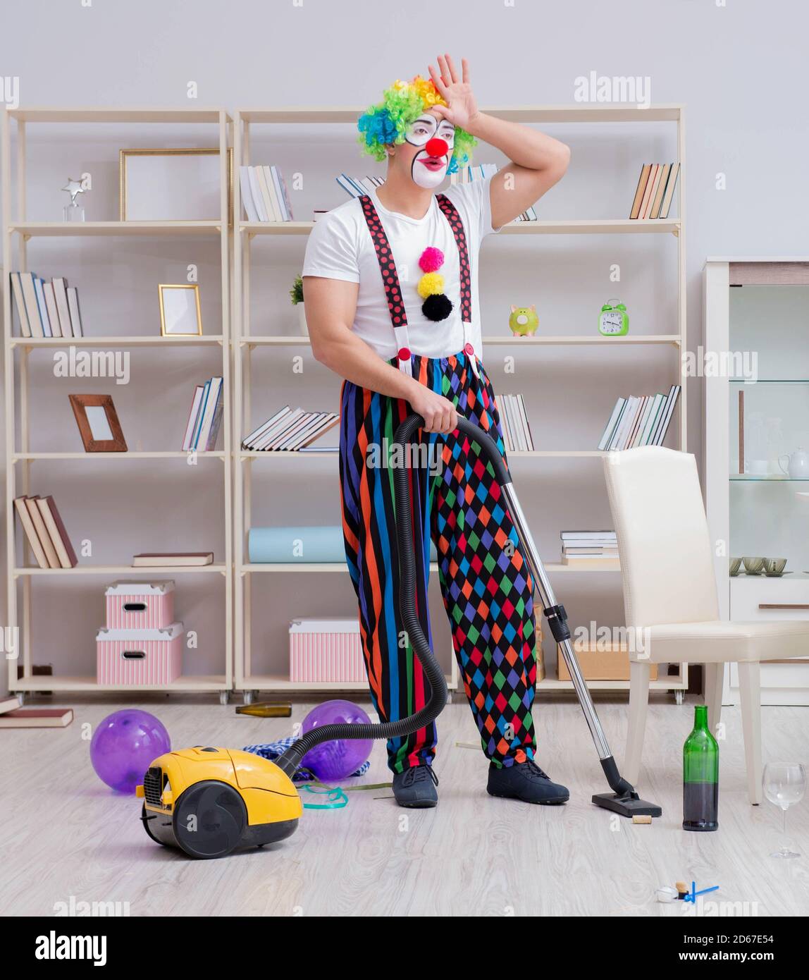 Funny clown doing cleaning at home Stock Photo - Alamy