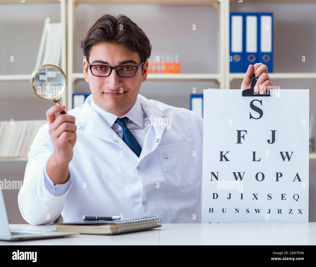 Doctor optician with letter chart conducting an eye test check Stock ...