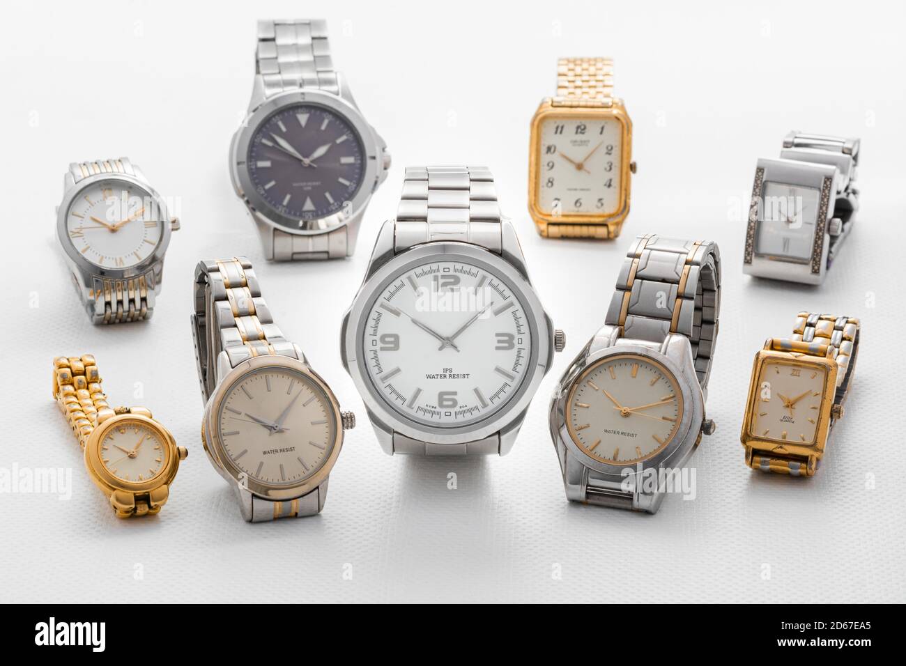 elegant and classic silver and gold wrist analog watches on white ...