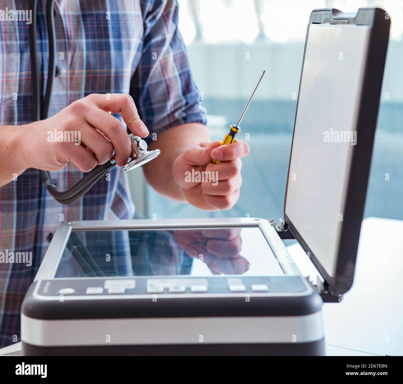 The repairman repairing broken color printer Stock Photo - Alamy
