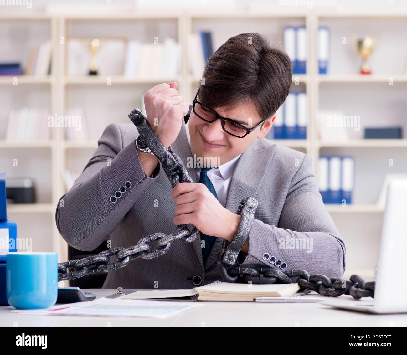 The businessman tied with chains to his work Stock Photo - Alamy