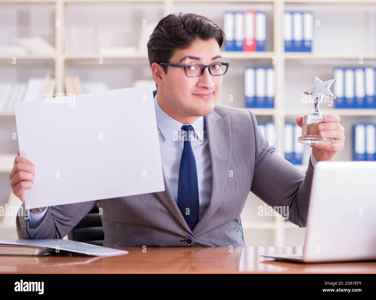 Businessman in office holding a blank message board Stock Photo - Alamy