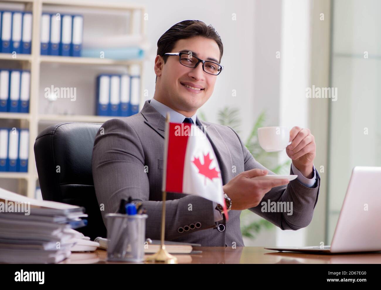 The businessman with canadian flag in office Stock Photo - Alamy