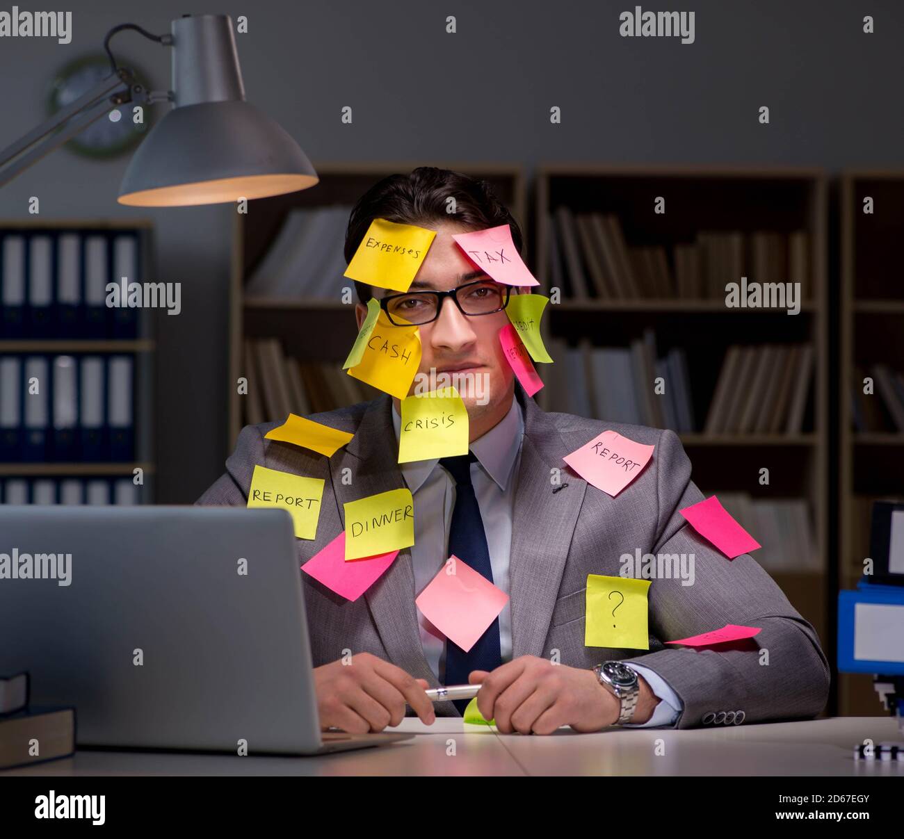 Businessman staying late to sort out priorities Stock Photo - Alamy