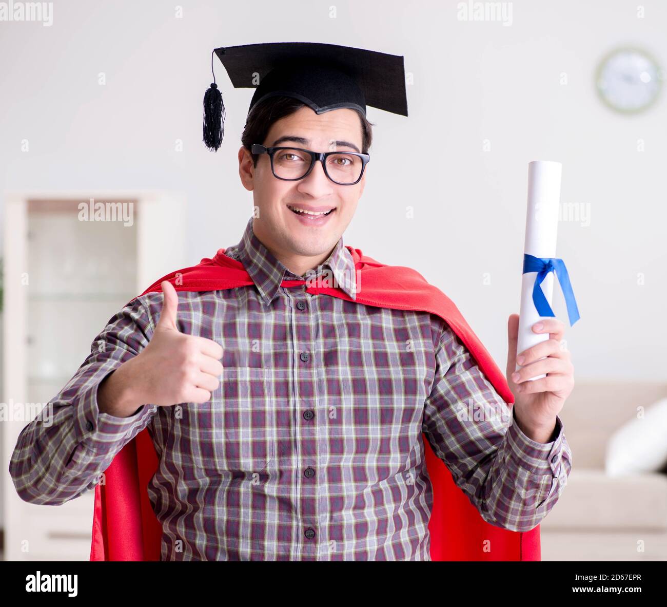 Super hero student graduating wearing mortar board cap Stock Photo - Alamy
