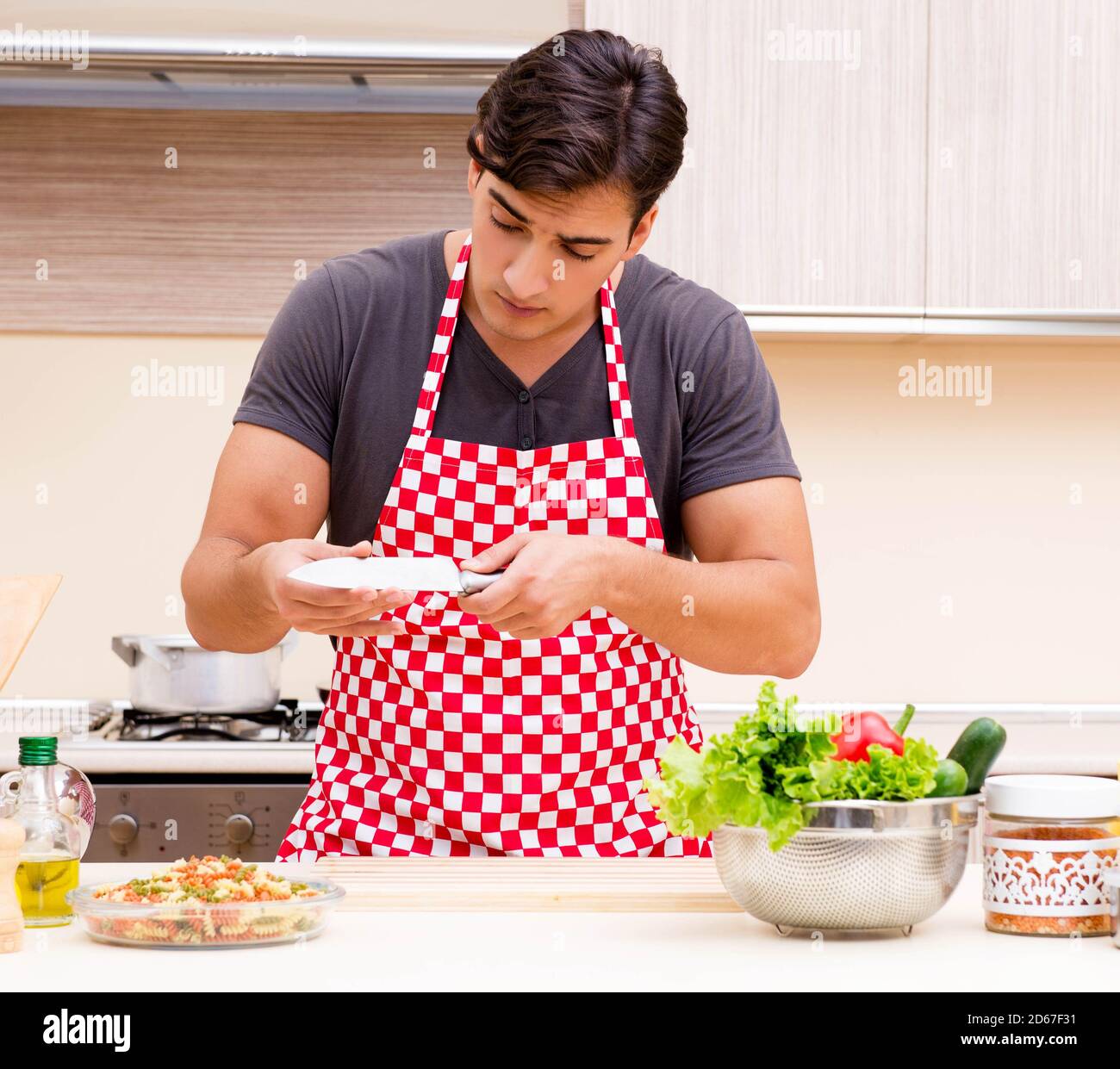 The man male cook preparing food in kitchen Stock Photo - Alamy