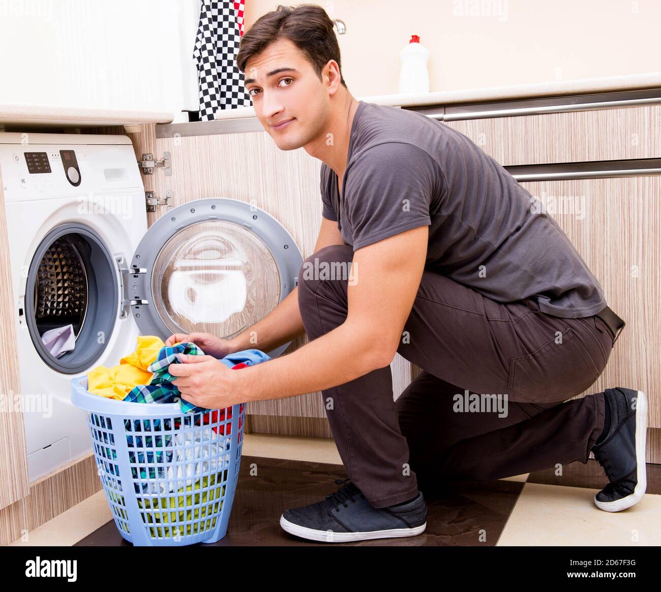 The young husband man doing laundry at home Stock Photo - Alamy