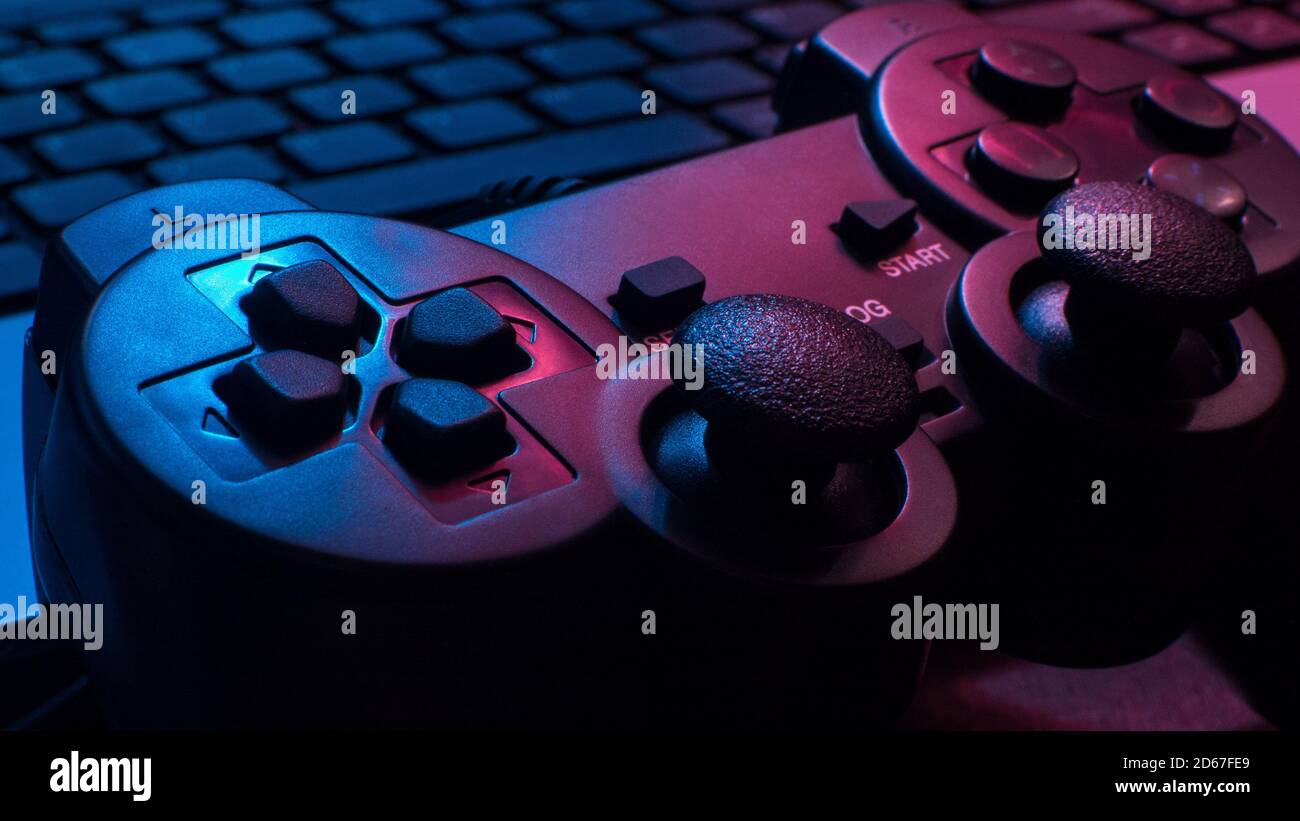 Game controller under blue and red lights in a dark room Stock Photo ...
