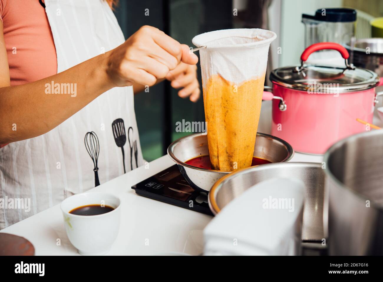 Woman girl in kitchen cooking pouring drip hot thai tea, food sweet ...
